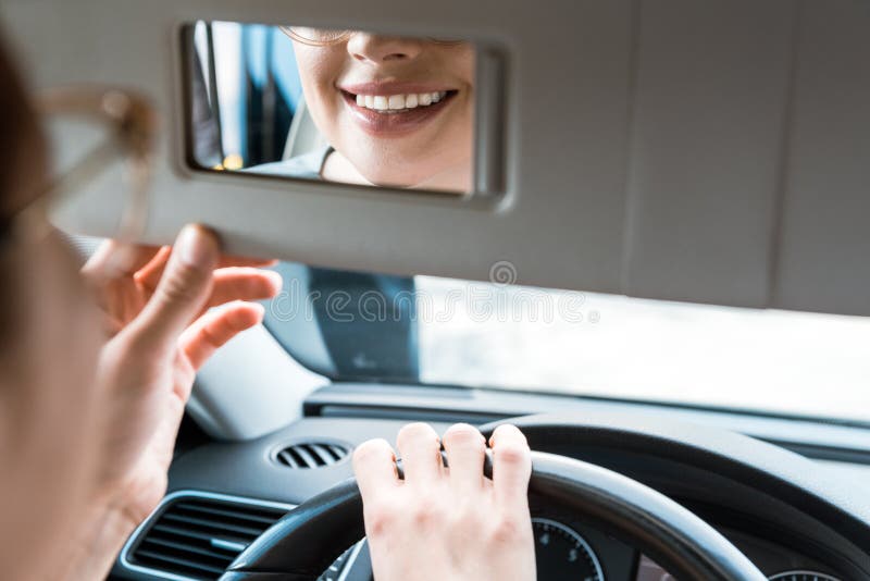 View of Smiling Woman Looking at Mirror in Car Stock Image - Image of ...