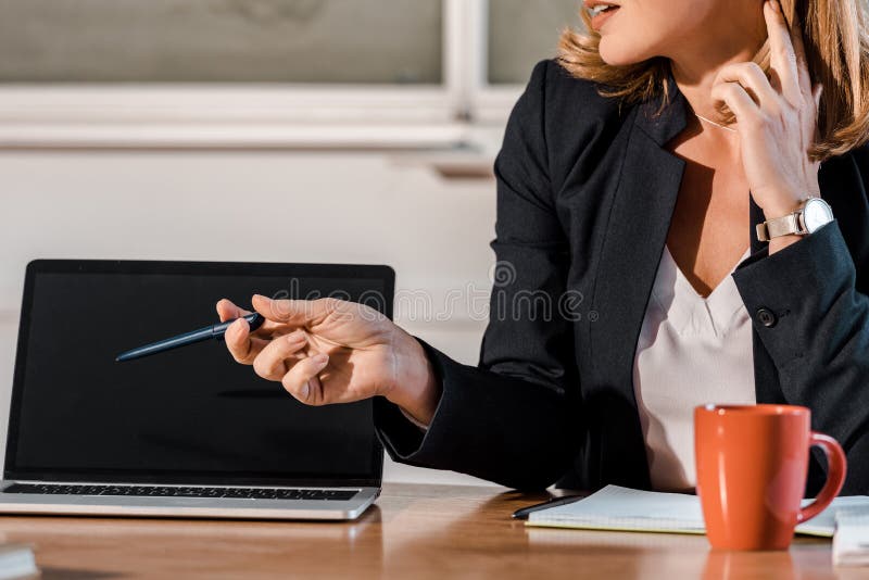 Cropped View of Teacher Sitting at Desk and Pointing at Laptop Stock ...