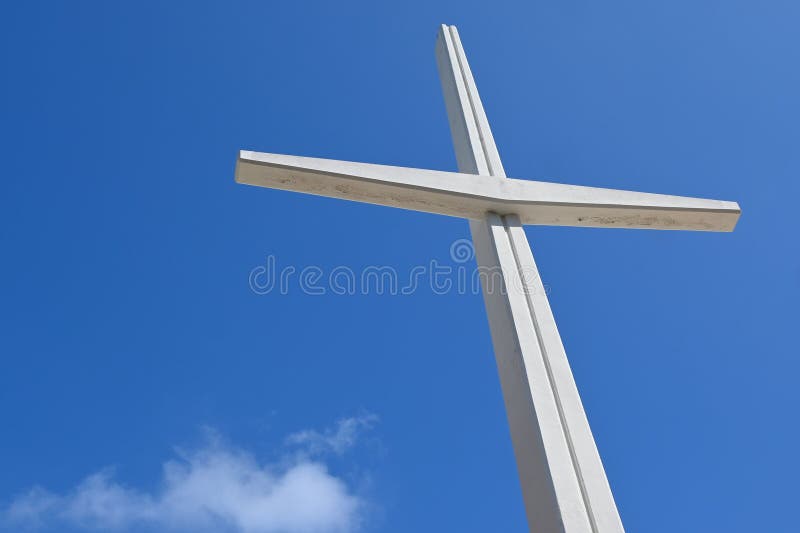 Cross Against a Bright Blue Sky with One Cloud in Lower Left Corner ...