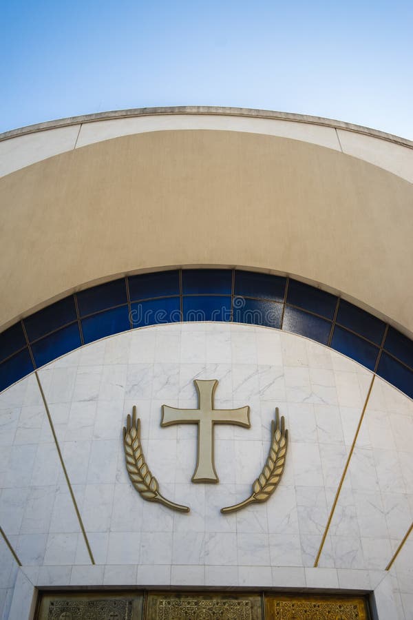 Cross on a Building with White Walls Under a Blue Sky and Sunlight ...