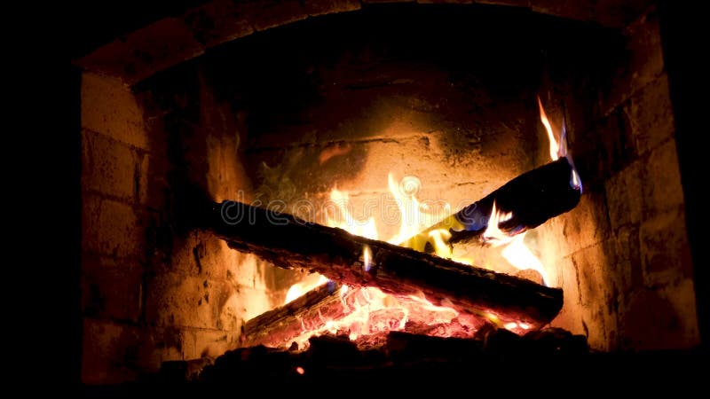 A Cross of Burning Logs in the Fireplace Two Logs Lie Side by Side on ...