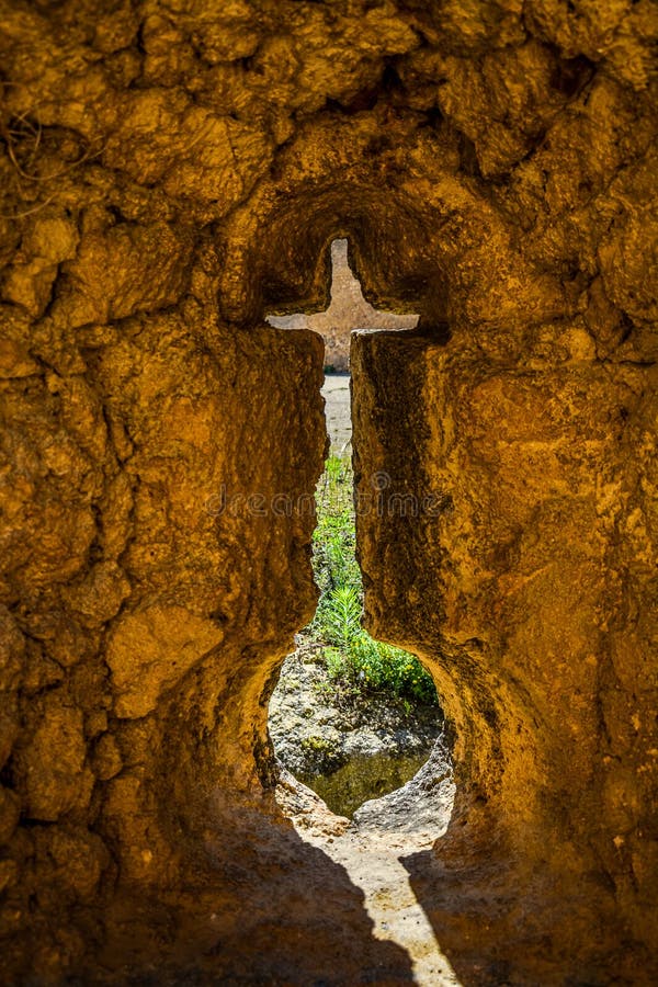 A Cross is Embedded into a Hole in the Side of Some Rocks Stock Photo ...