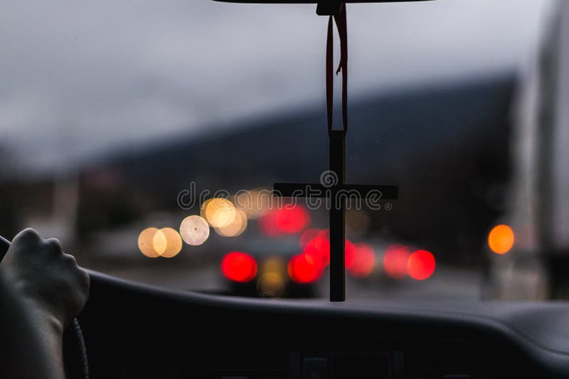 Cross in a Windshield Against Lights from Traffic Stock Image - Image ...