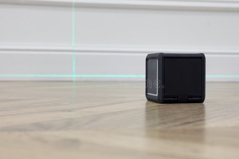 Cross Line Laser Level on Floor in Front of White Wall Stock Photo ...