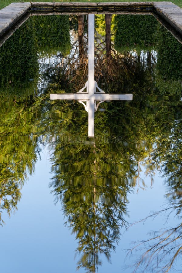 A Cross in a Reflecting Pond in a Garden Stock Photo - Image of ...