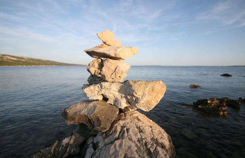 Cross, Rocks Stacked One One Top of Another on Beach Stock Photo ...