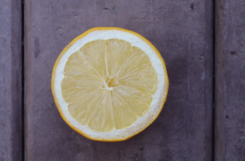 Cross-section of a Lemon Placed on a Brown Table in Natural Light Stock ...