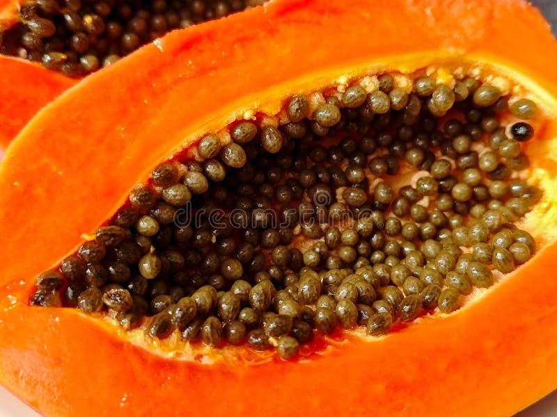 Cross-section of a Papaya Fruit Cut Open with the Seeds Still Attached ...