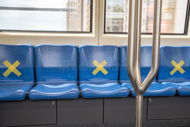 Cross Stickers Applied on Seats in a Train for Social Distancing Rules ...