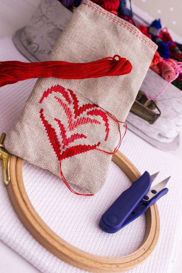 Cross stitch, red color stock image. Image of creation - 146548021