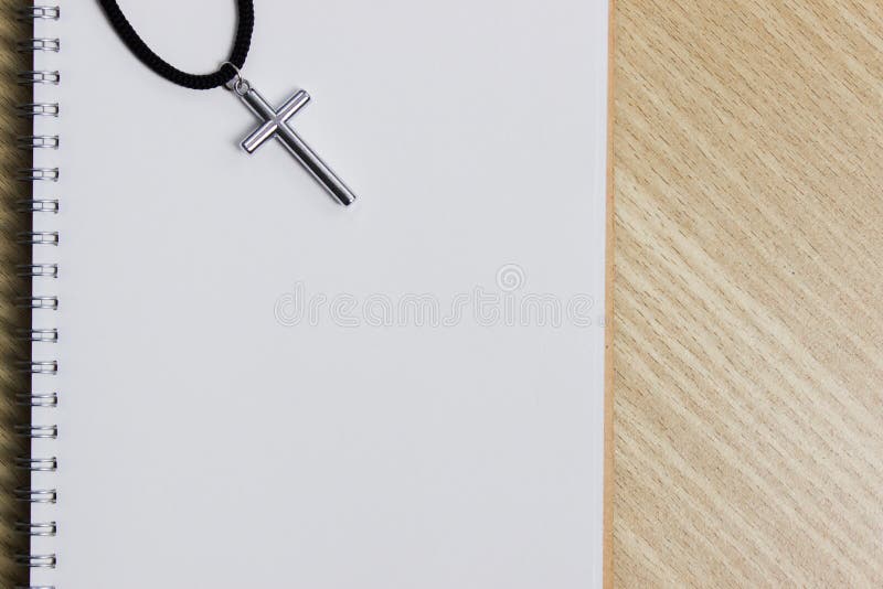 A Cross with White Notebook on a Wooden Table. Stock Photo - Image of ...