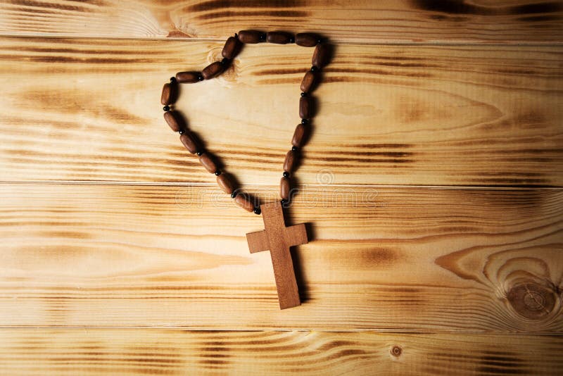 Cross on a wooden table stock photo. Image of paradise - 217260824