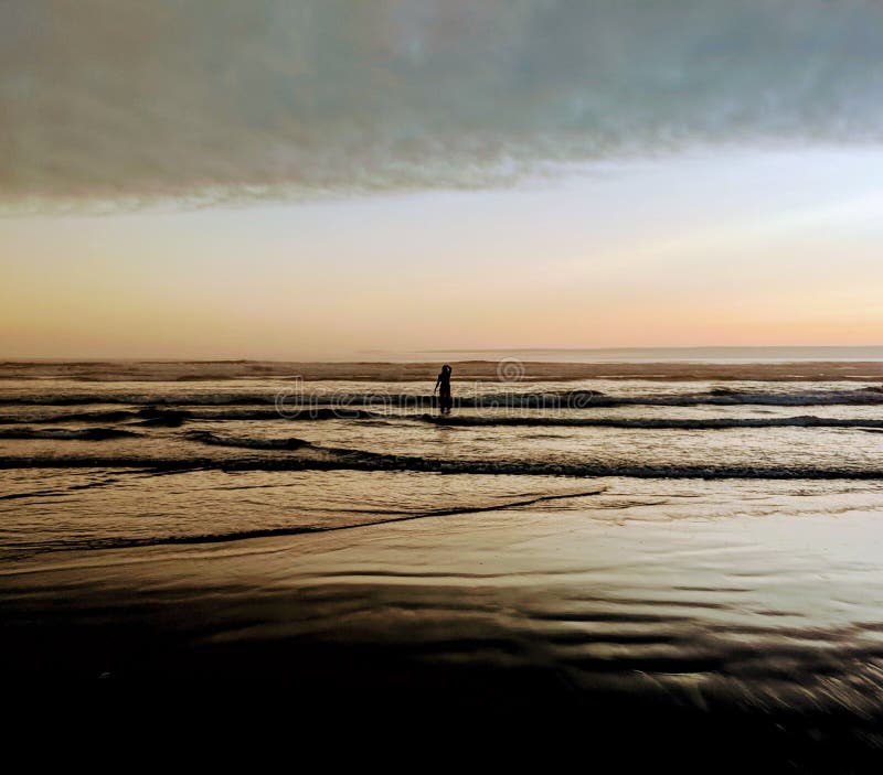Crossing Waves at Sunset Emerging Silhouette Stock Photo - Image of ...