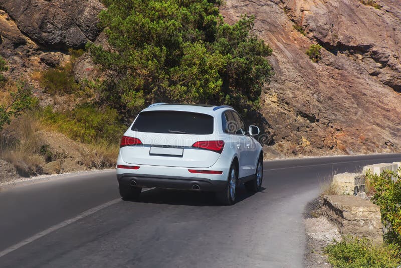 Crossover Moves Along a Winding Road in the Mountains Stock Image ...