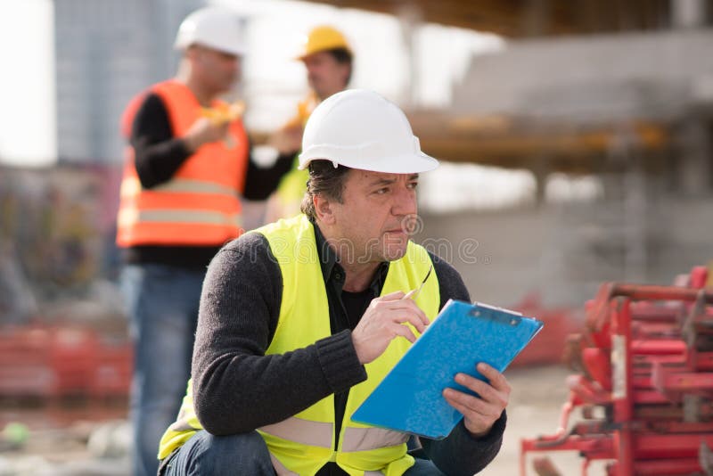 Foreman Working on Construction Site Stock Image - Image of examining ...