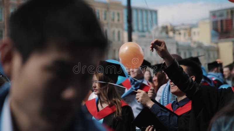 Crowd of Cheering Multicultural Graduating Students Outdoors Stock ...