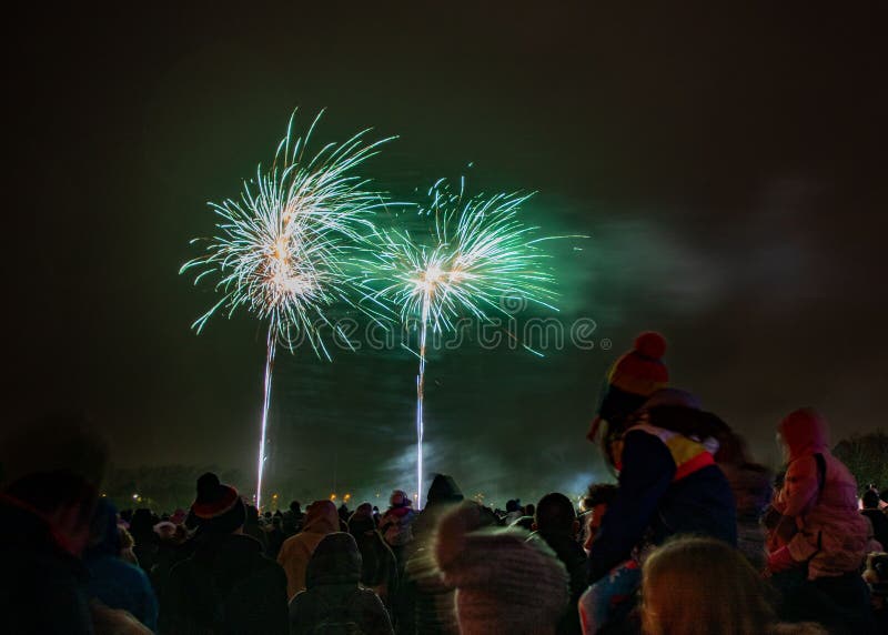 Crowd Enjoying the Beautiful Fireworks at Night during an Outdoor Event ...