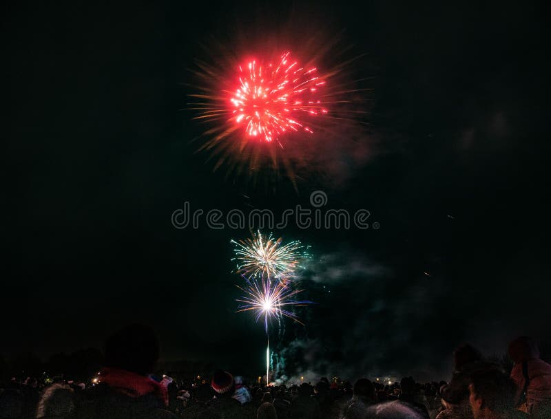 Crowd Enjoying the Beautiful Fireworks at Night during an Outdoor Event ...