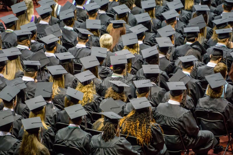 A Group Of Graduates Throwing Graduation Caps In The Air Stock Photo ...