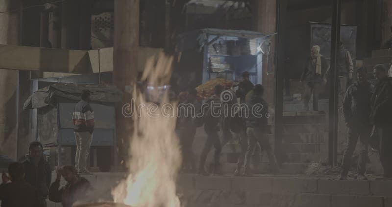A Group of People Gather Around a Fire Inside a Building Stock Footage ...