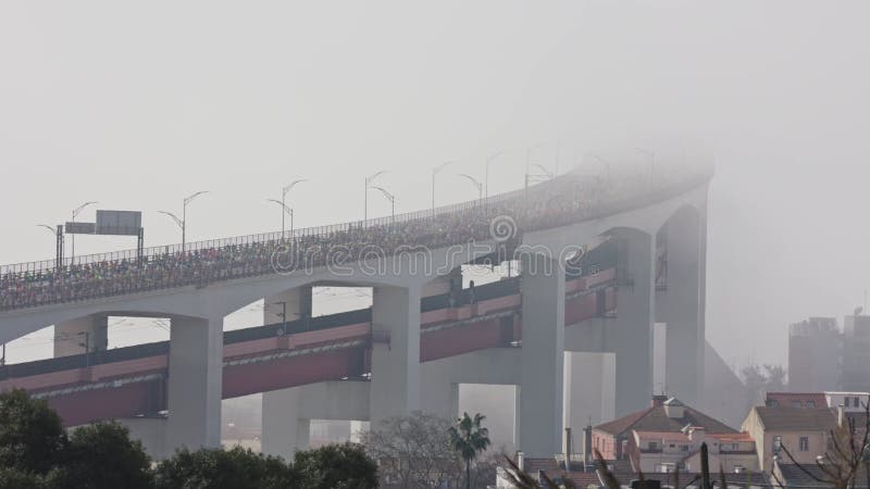 A Crowd of People Running Half Marathon on the Bridge in a Thick White ...