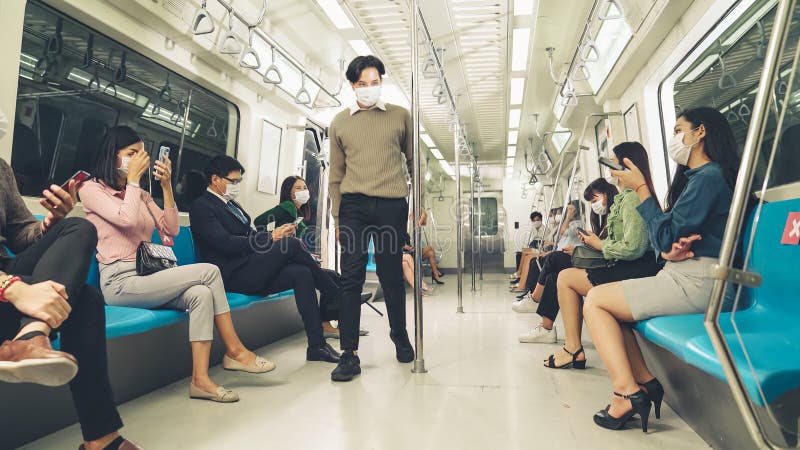 Crowd Of People Wearing Face Mask On A Crowded Public Subway Train