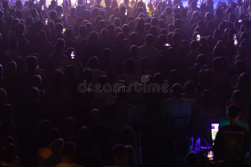 A Crowd of Spectators Watching a Performance in Dim Light. Stock Photo ...
