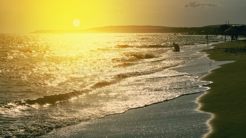 Crowded Beach in the Evening at Sunset Stock Photo - Image of ...