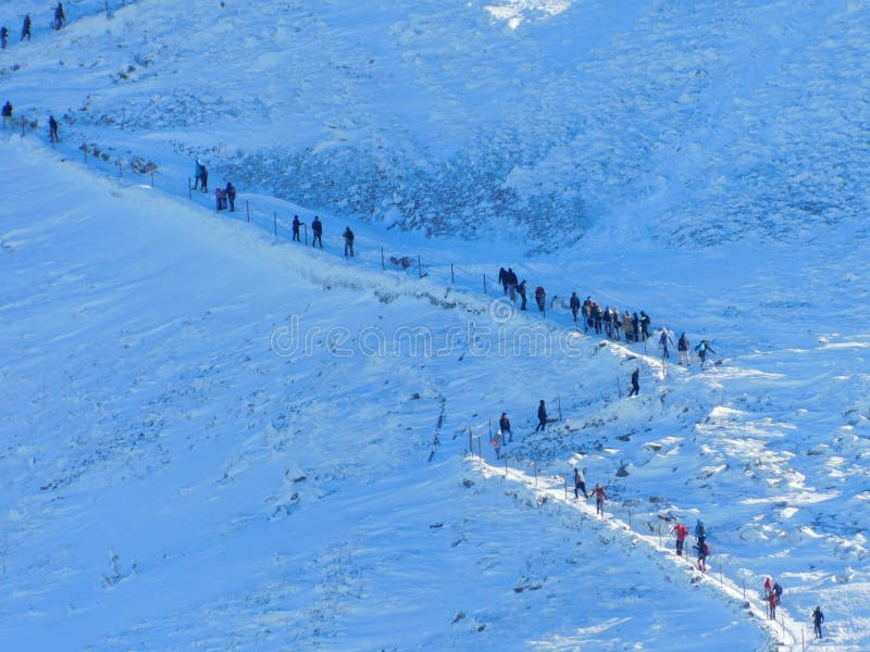 Crowded path in mountains stock image. Image of snow - 87496355