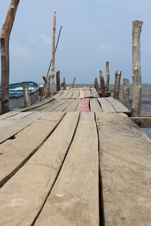 Rickety Dock Extends into Blue Sea Beneath Blue Sky Stock Image - Image ...