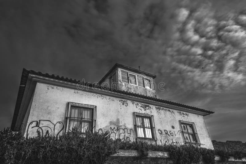 Crumbling Facade of an Abandoned House Featuring Graffiti and Barred ...