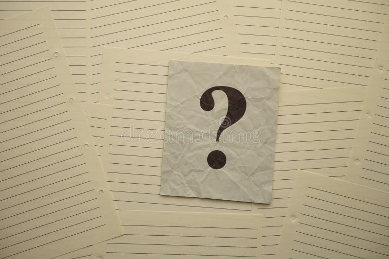 Crumpled Grey Paper Note with Question Mark on it Lying on Lined ...