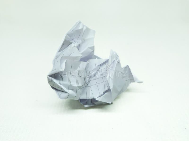 A Crumpled Paper with a Grid Pattern Lies on a White Surface ...