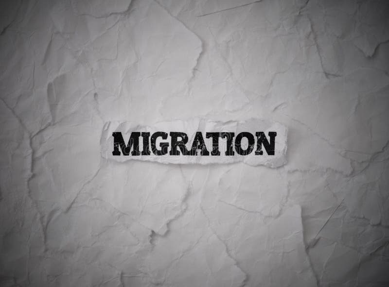 Crumpled Piece of Paper with Word Migration on Torn White Paper Pieces ...