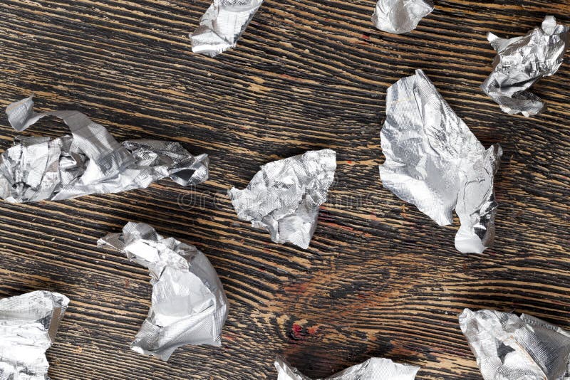 Crumpled Pieces of Foil from Chocolate on a Wooden Table Stock Photo ...