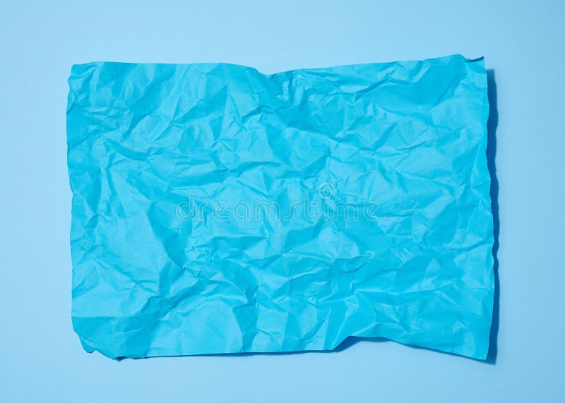 Crumpled Rectangular Sheet of Blue Paper on a Blue Background, Top View ...