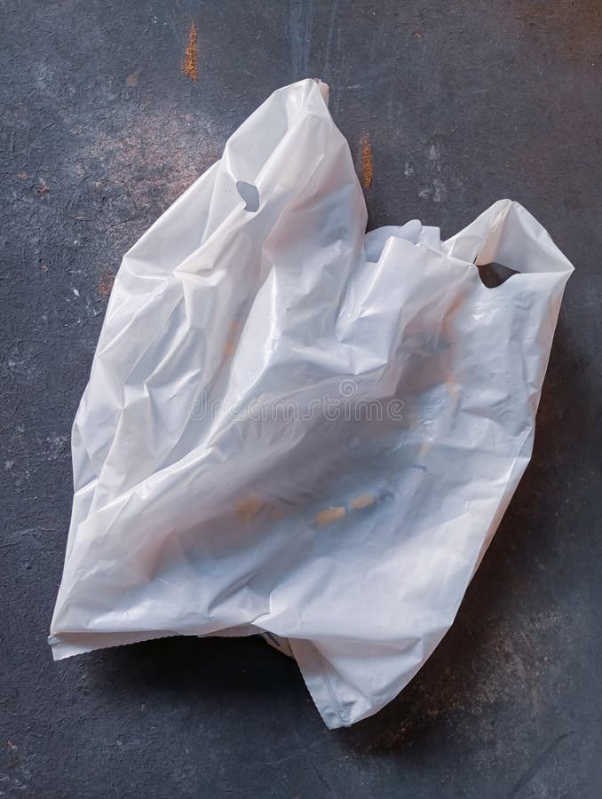 Crumpled White Plastic Bag on Dark Floor Stock Photo - Image of garbage ...