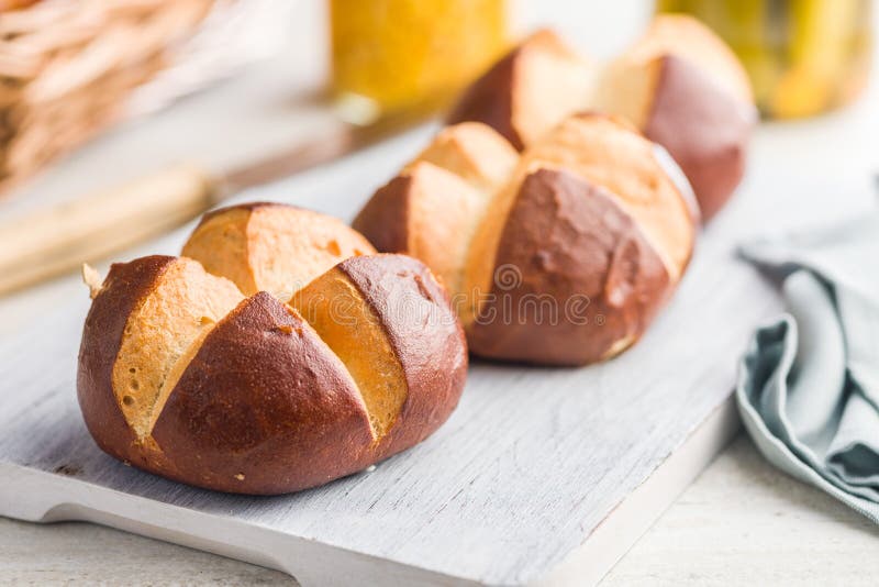 Crunchy Bavarian Buns on Cutting Board on Kitchen Table Stock Image ...