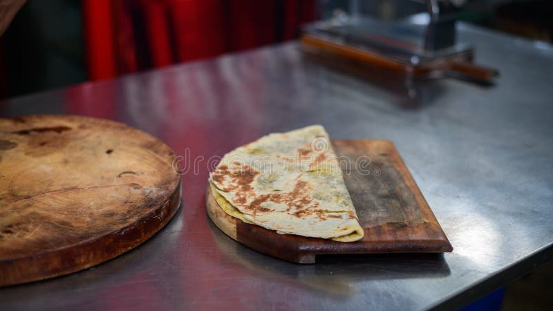 Crunchy Folded Single Tortilla Bread on a Wooden Plate on the Kitchen ...