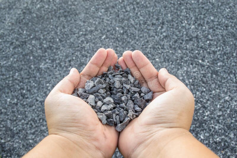 Crushed stone in hand stock image. Image of material - 68468411