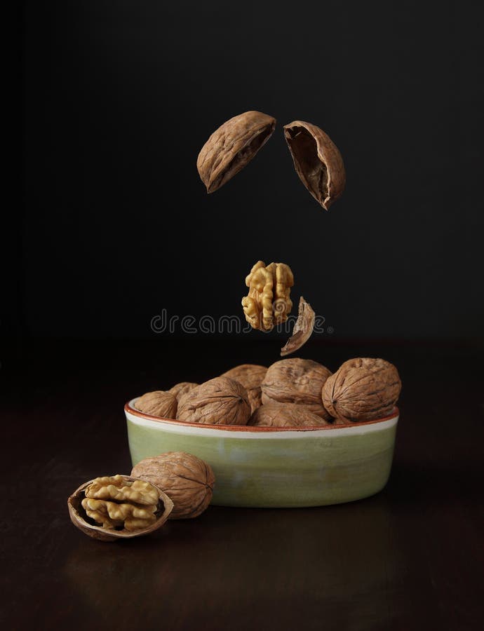 Crushed Walnut Pouring, Handful of Walnuts on Wooden Background Stock ...