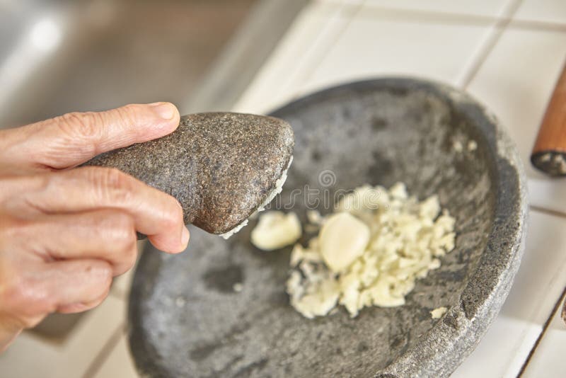 Crushing garlic stock image. Image of chrushed, stone - 49784407