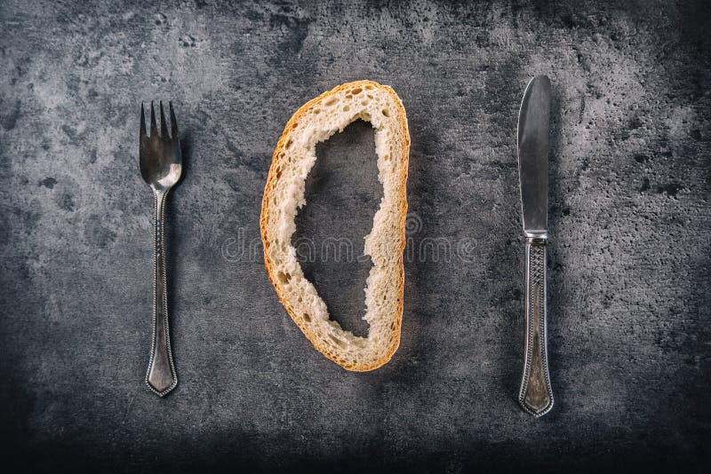 Crust of Bread Fork and Knife on Concrete Board. Toned Image Stock ...