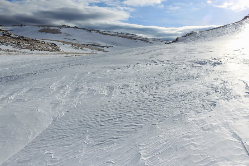 Crust of Ice on the Snow Cover in the Mountains. Blue Sky and Clouds in ...