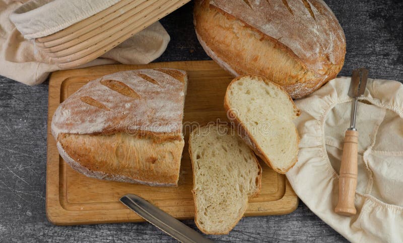 Crusty Bread Sliced on Rustic Background with Bannetone Stock Photo ...