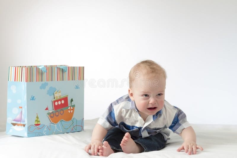 Crying Baby Boy with a Gift Package. Sad Infant in Hysterics. Stock ...