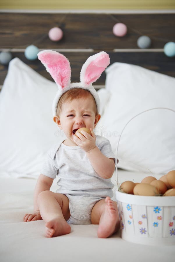 Crying Baby Eating an Egg in Bed Stock Photo - Image of charming ...