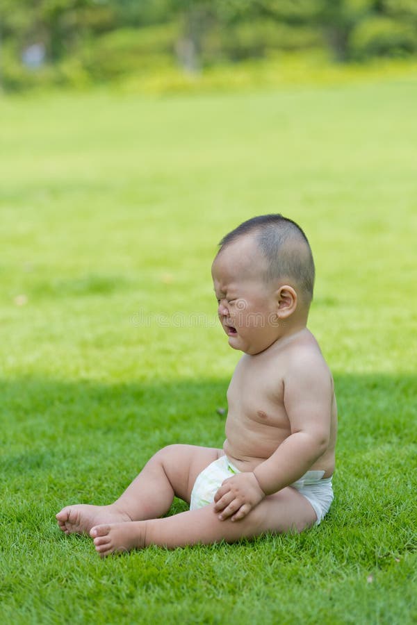 Crying Baby in the Park Lawn Stock Image - Image of grass, outdoors ...