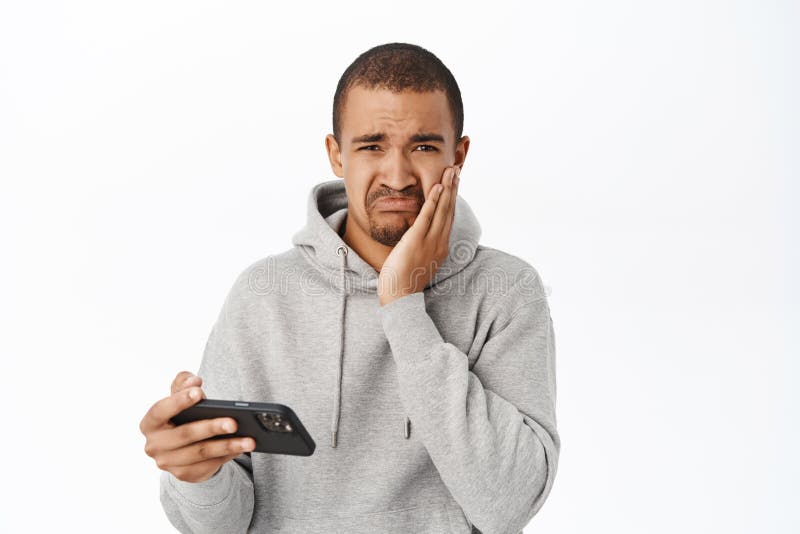 Crying Man Watching Smth Sad on Mobile Phone, Looking Gloomy, Standing ...