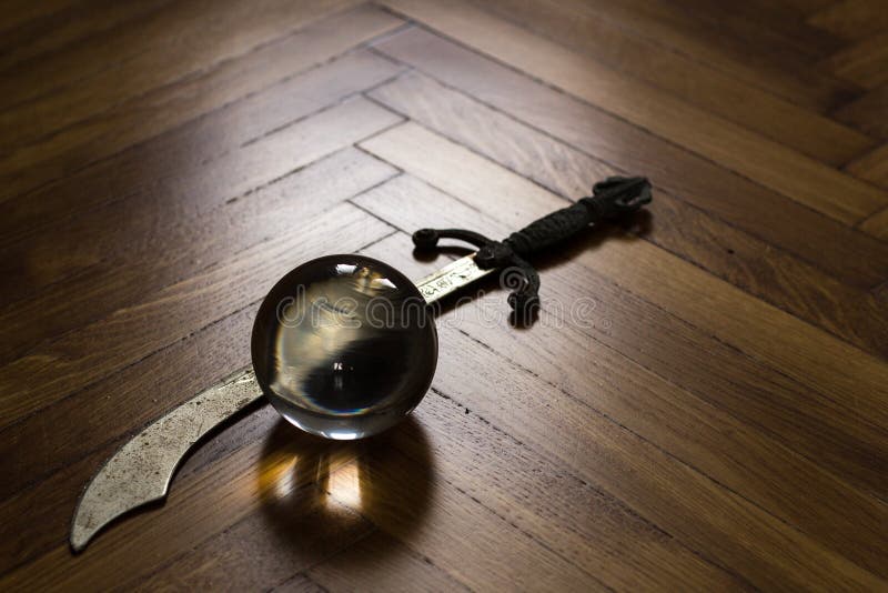 Crystal ball with dagger stock photo. Image of globe - 89926206